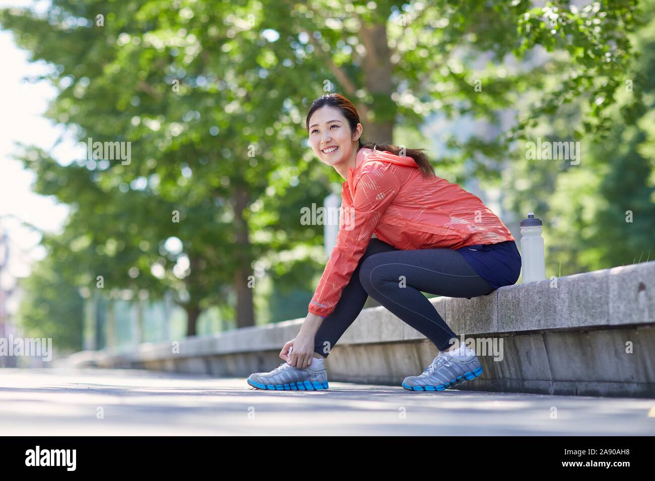 Young Japanese woman running downtown Tokyo Stock Photo - Alamy