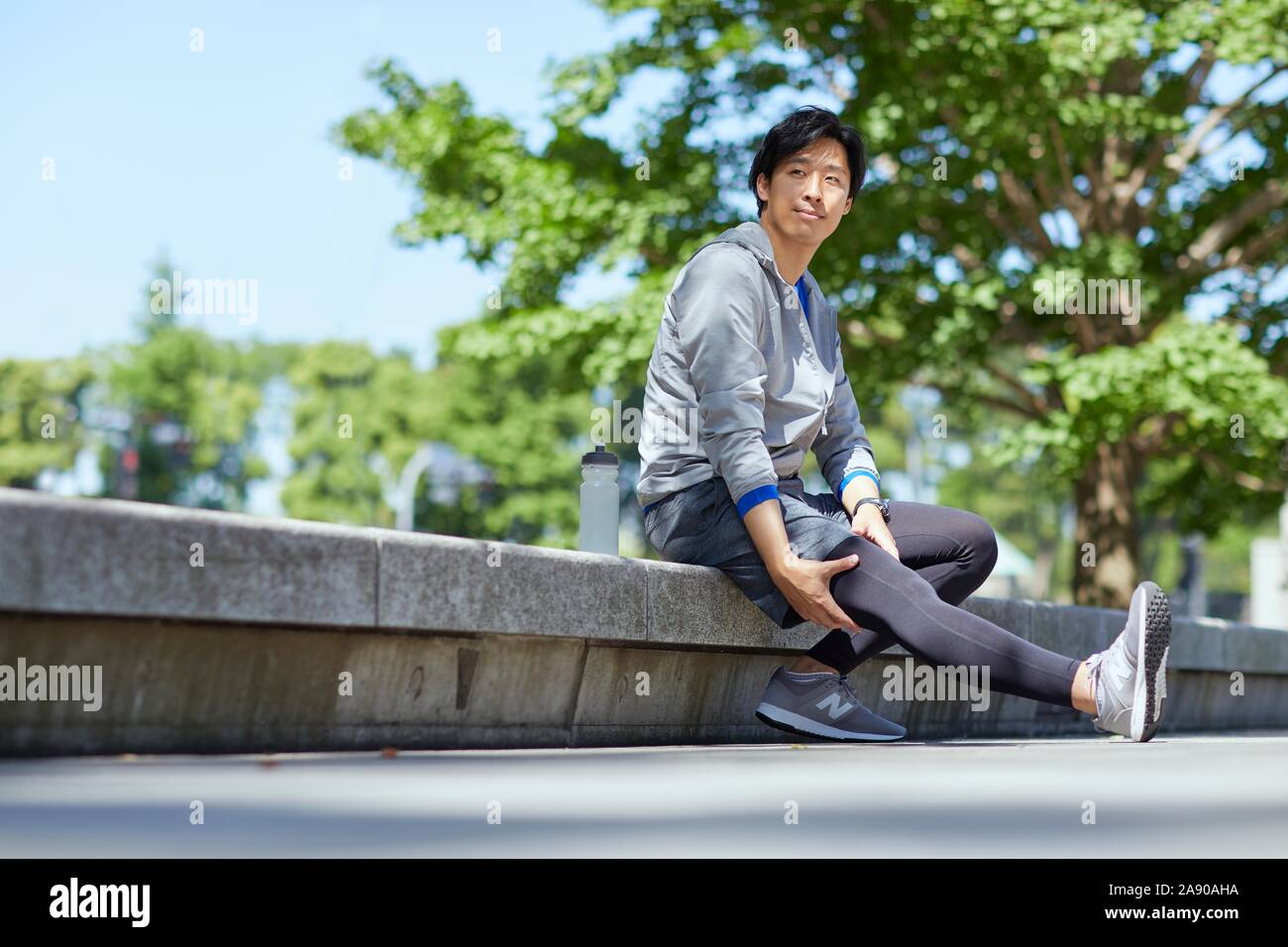 Young Japanese man running downtown Tokyo Stock Photo - Alamy