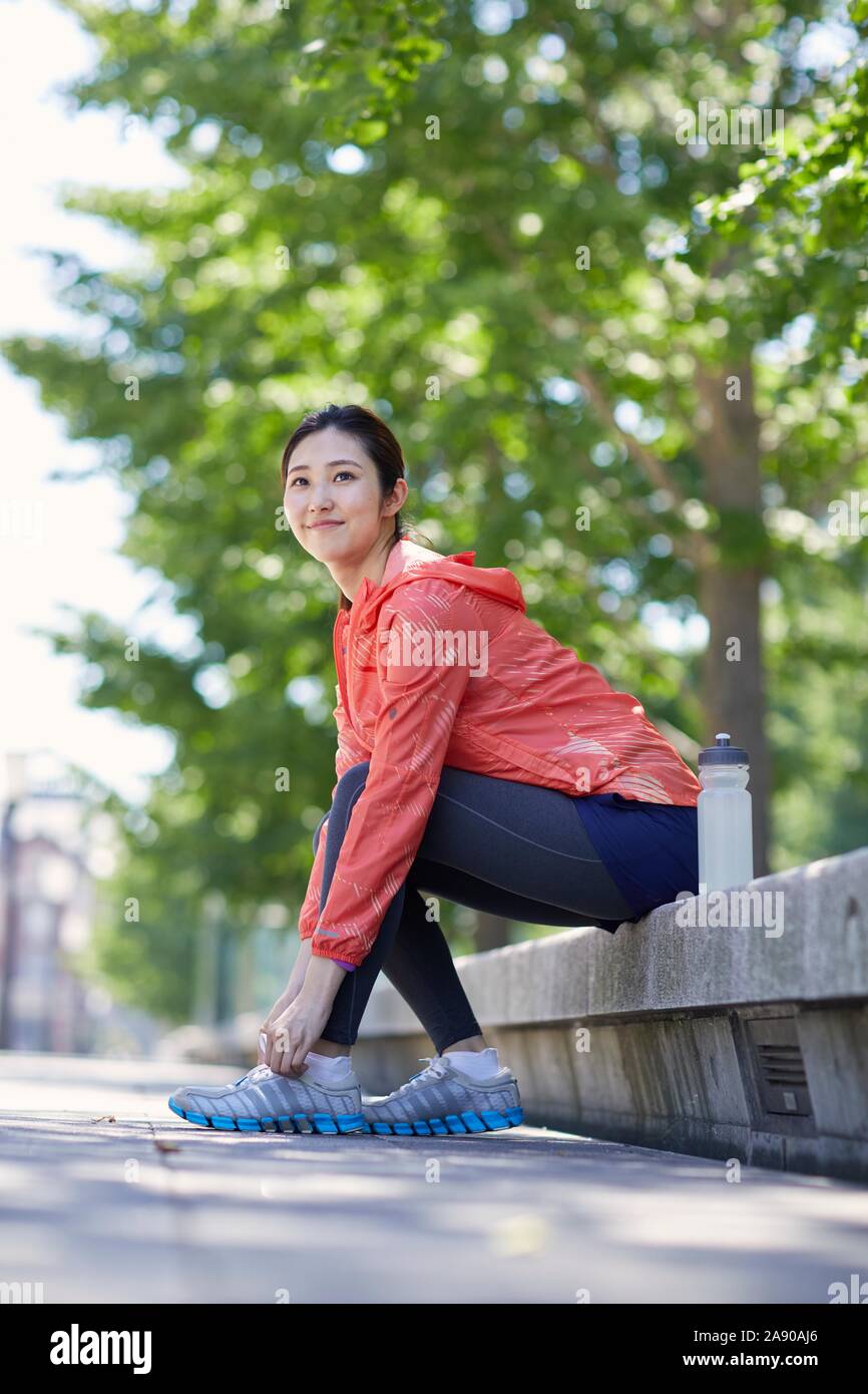 Young Japanese woman running downtown Tokyo Stock Photo - Alamy
