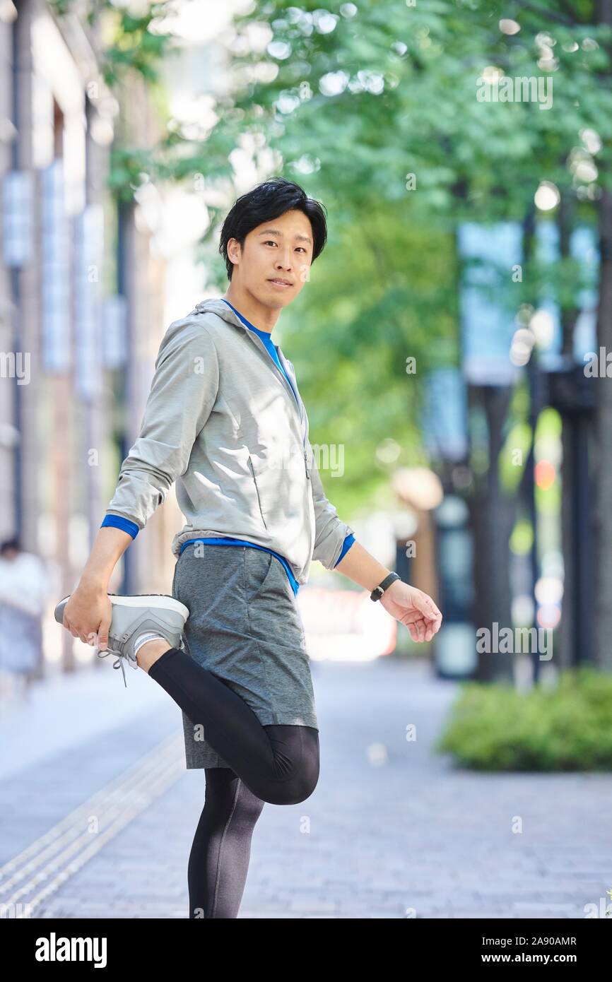 Young Japanese man running downtown Tokyo Stock Photo - Alamy