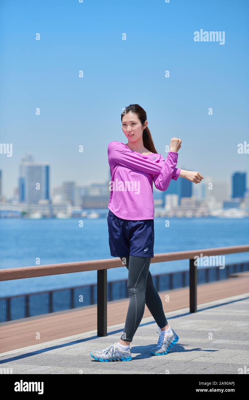 Young Japanese woman running downtown Tokyo Stock Photo - Alamy