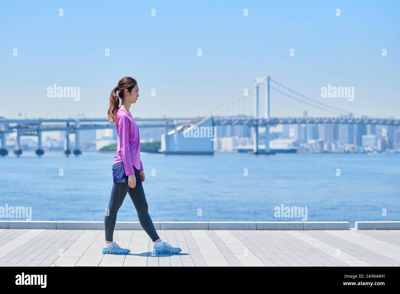 Young Japanese woman running downtown Tokyo Stock Photo - Alamy
