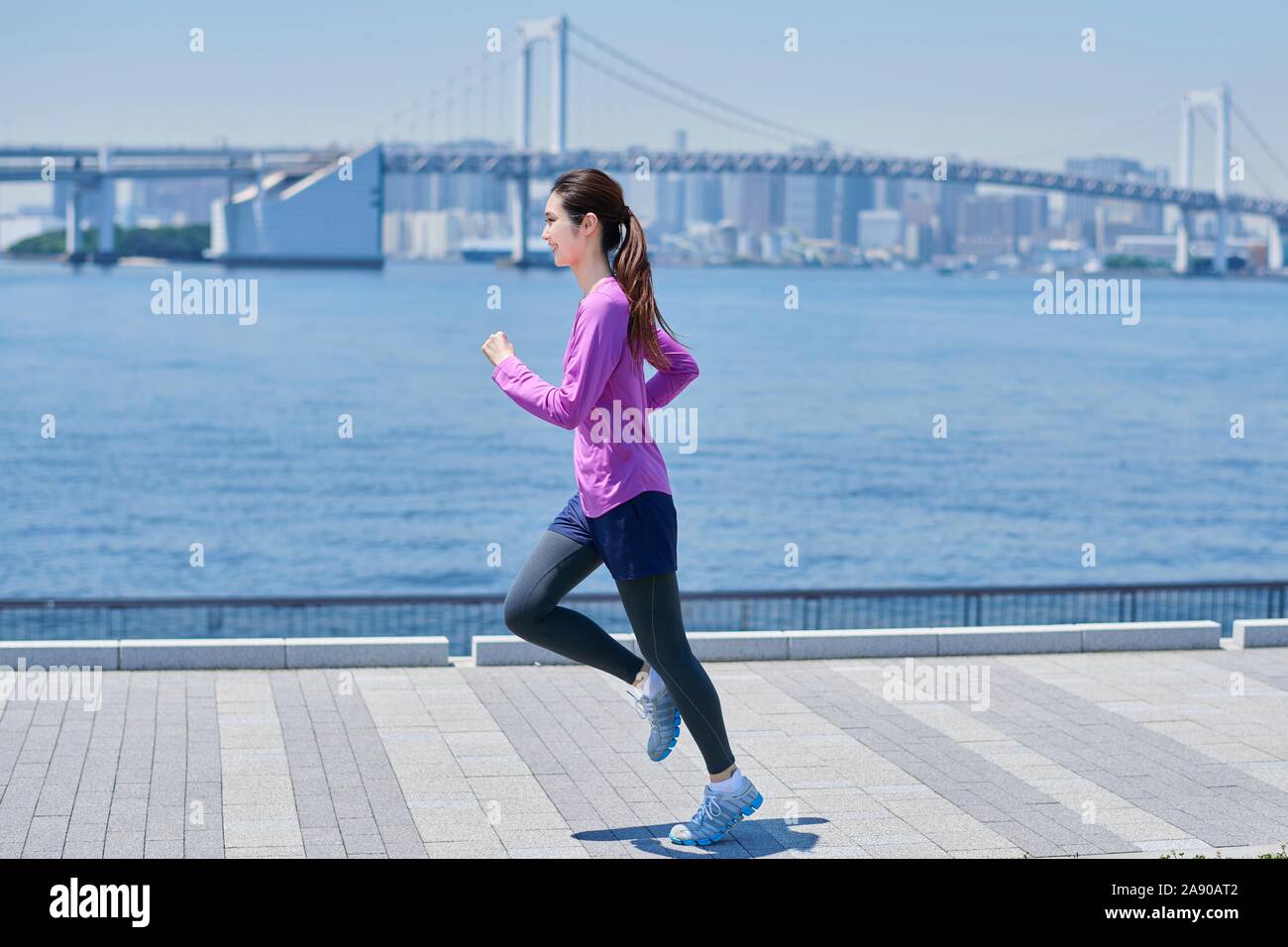 Young Japanese woman running downtown Tokyo Stock Photo - Alamy