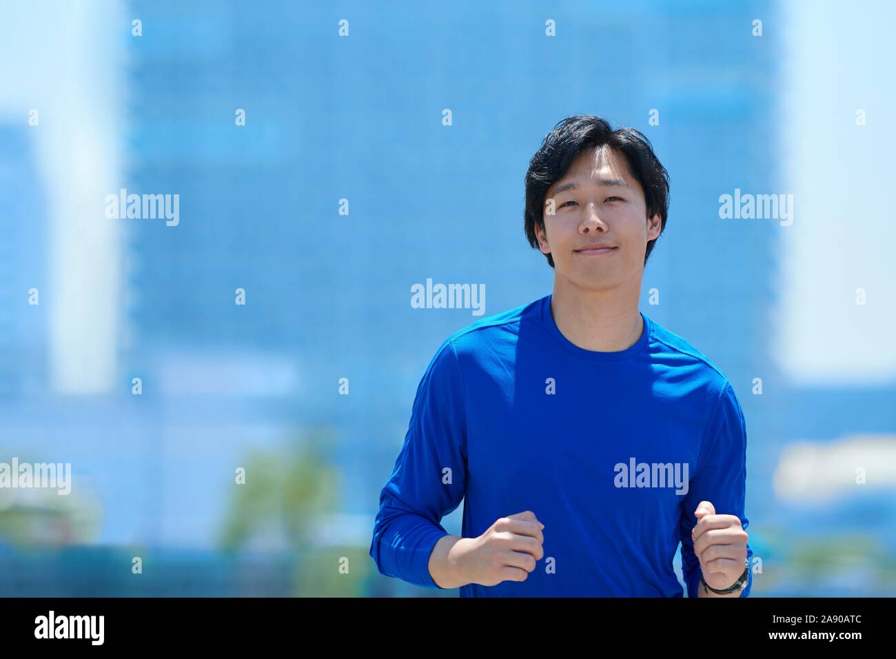 Young Japanese man running downtown Tokyo Stock Photo - Alamy