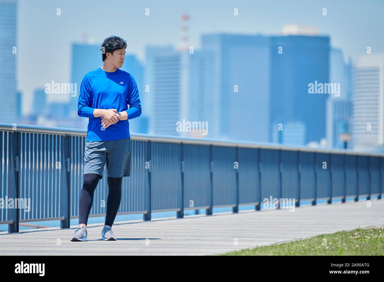 Young Japanese man running downtown Tokyo Stock Photo - Alamy