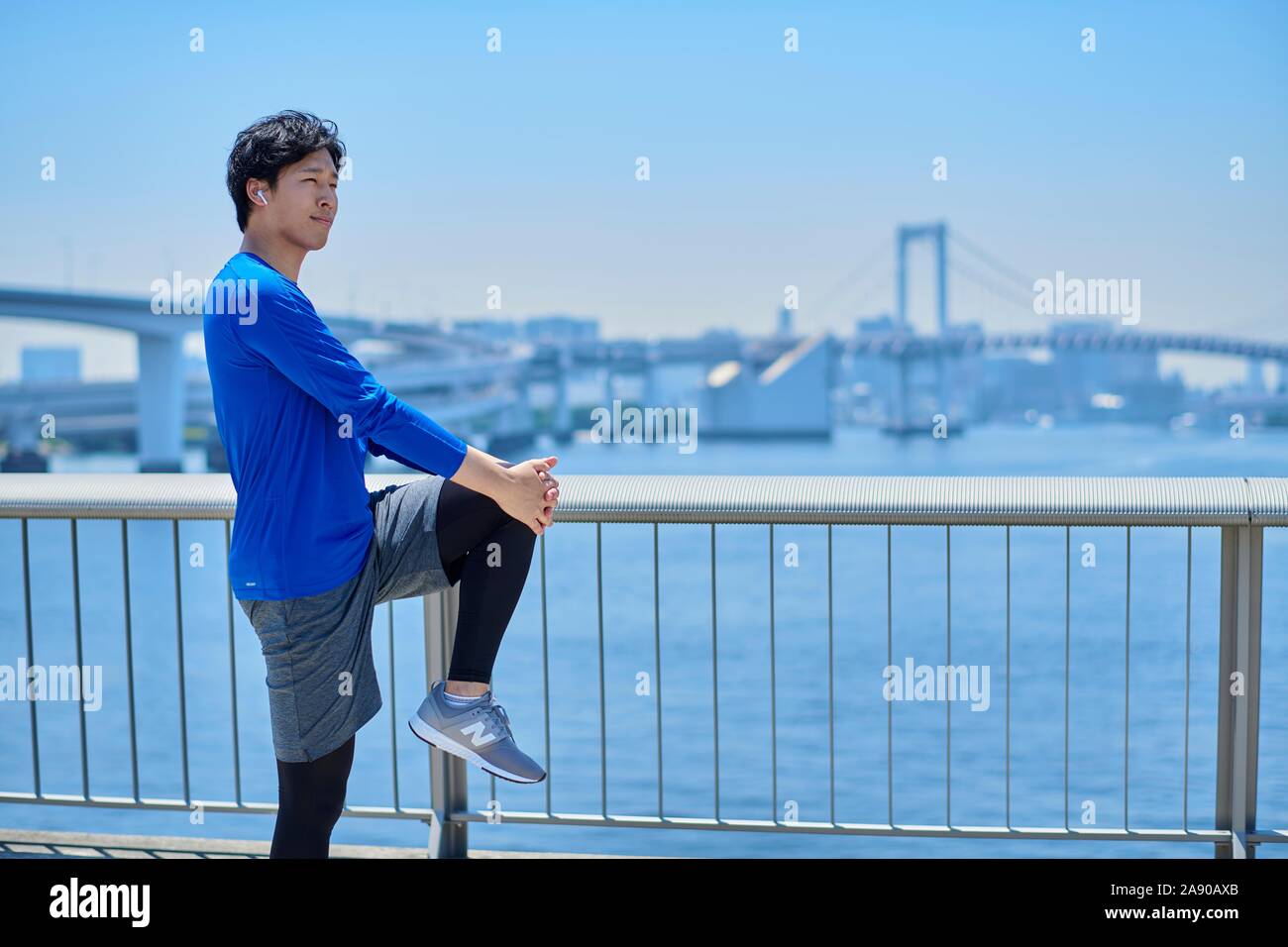 Young Japanese man running downtown Tokyo Stock Photo - Alamy