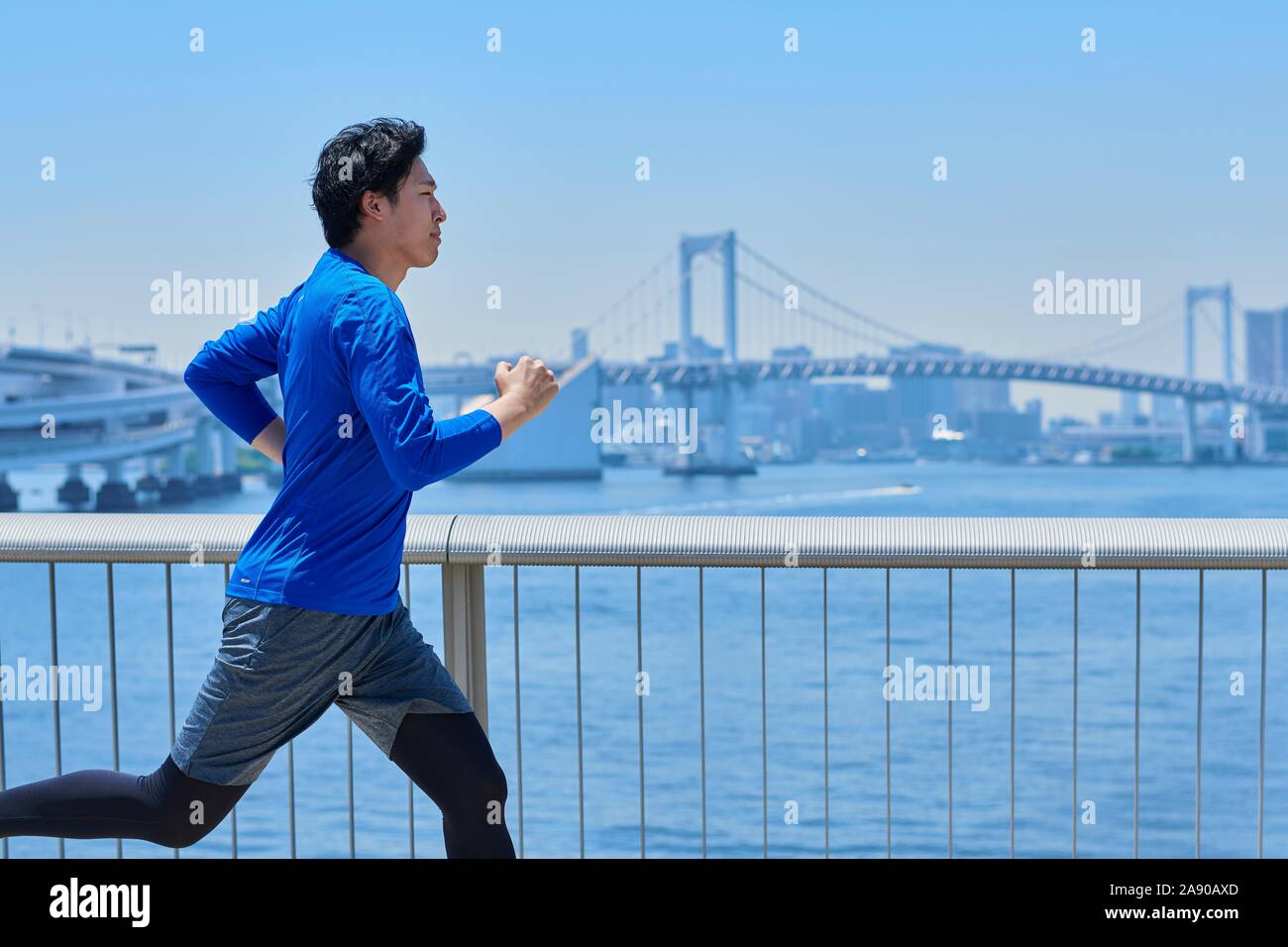 Young Japanese man running downtown Tokyo Stock Photo - Alamy