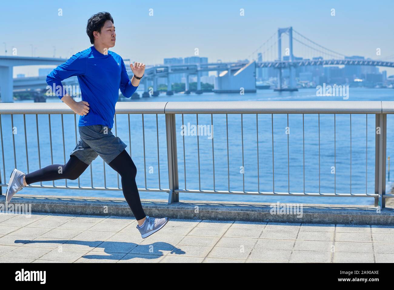 Young Japanese man running downtown Tokyo Stock Photo - Alamy