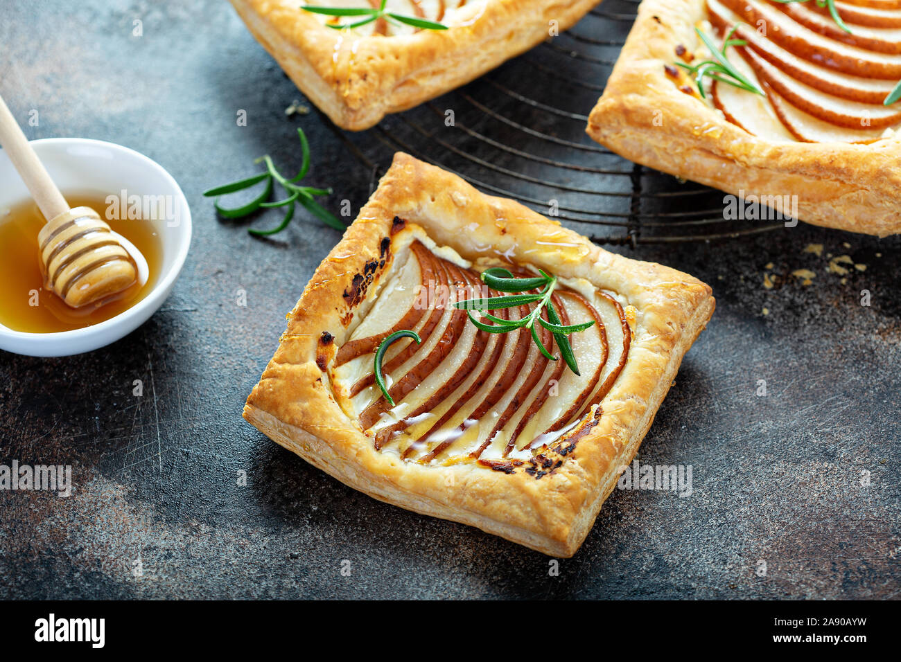 Puff pastries with thinly sliced pear, rosemary and honey, fall ...