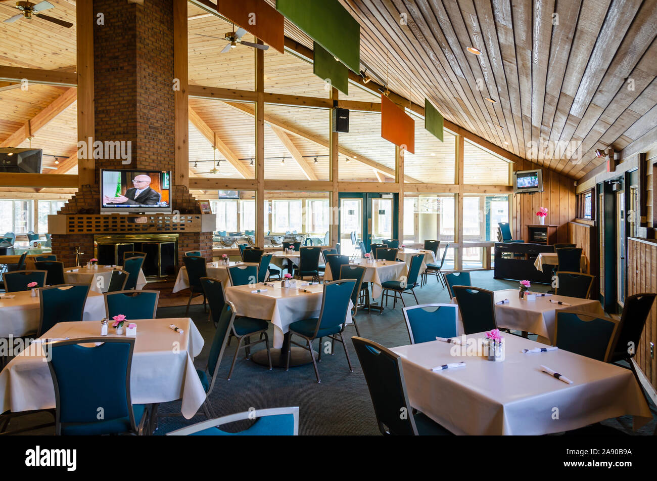 The inside of a restaurant. Numerous empty tables are seen in the ...