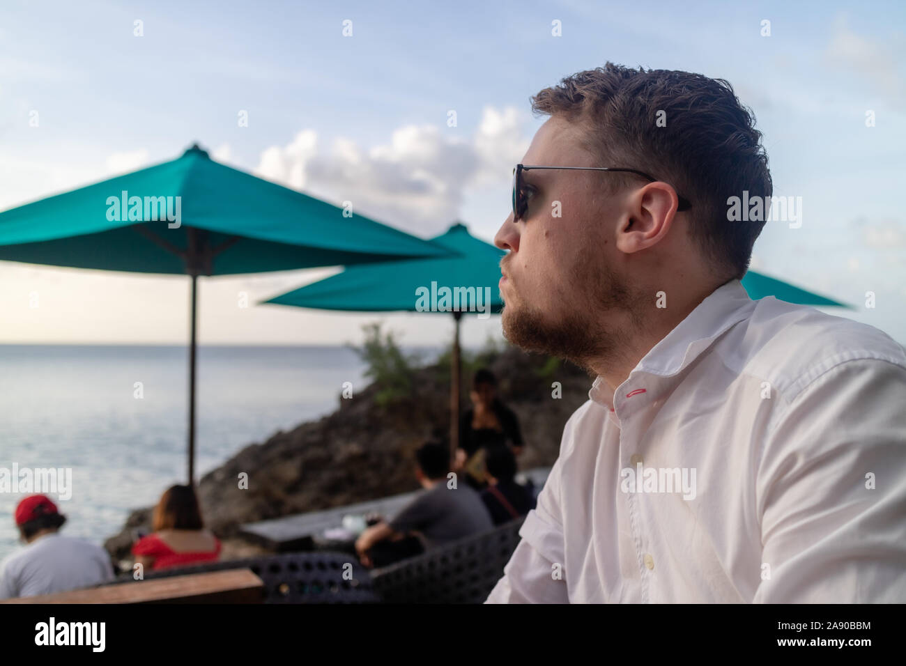 A handsome young man in sunglasses on holiday Stock Photo - Alamy