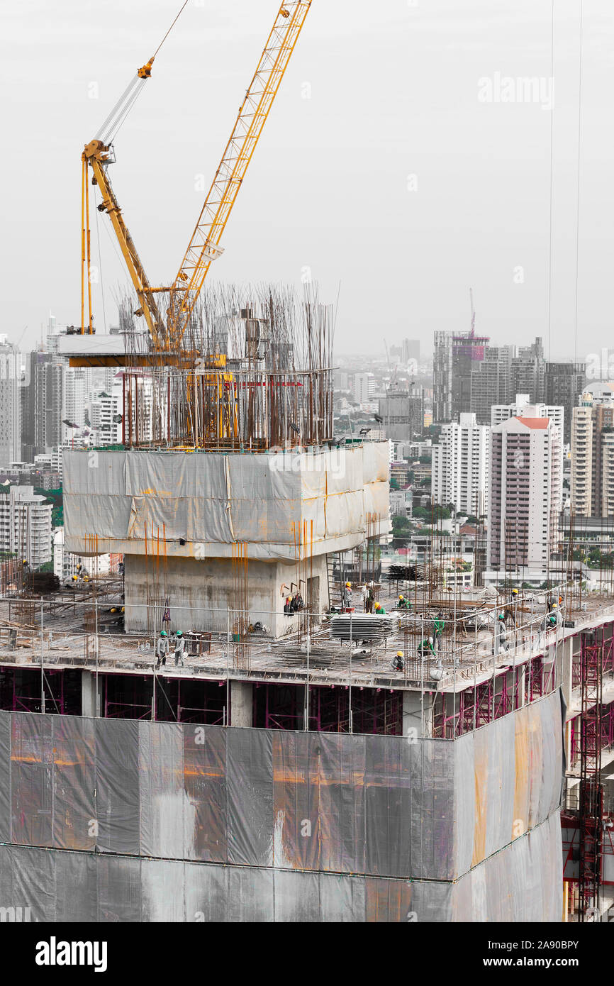 Aerial view of a building construction with tower crane, scaffolding ...