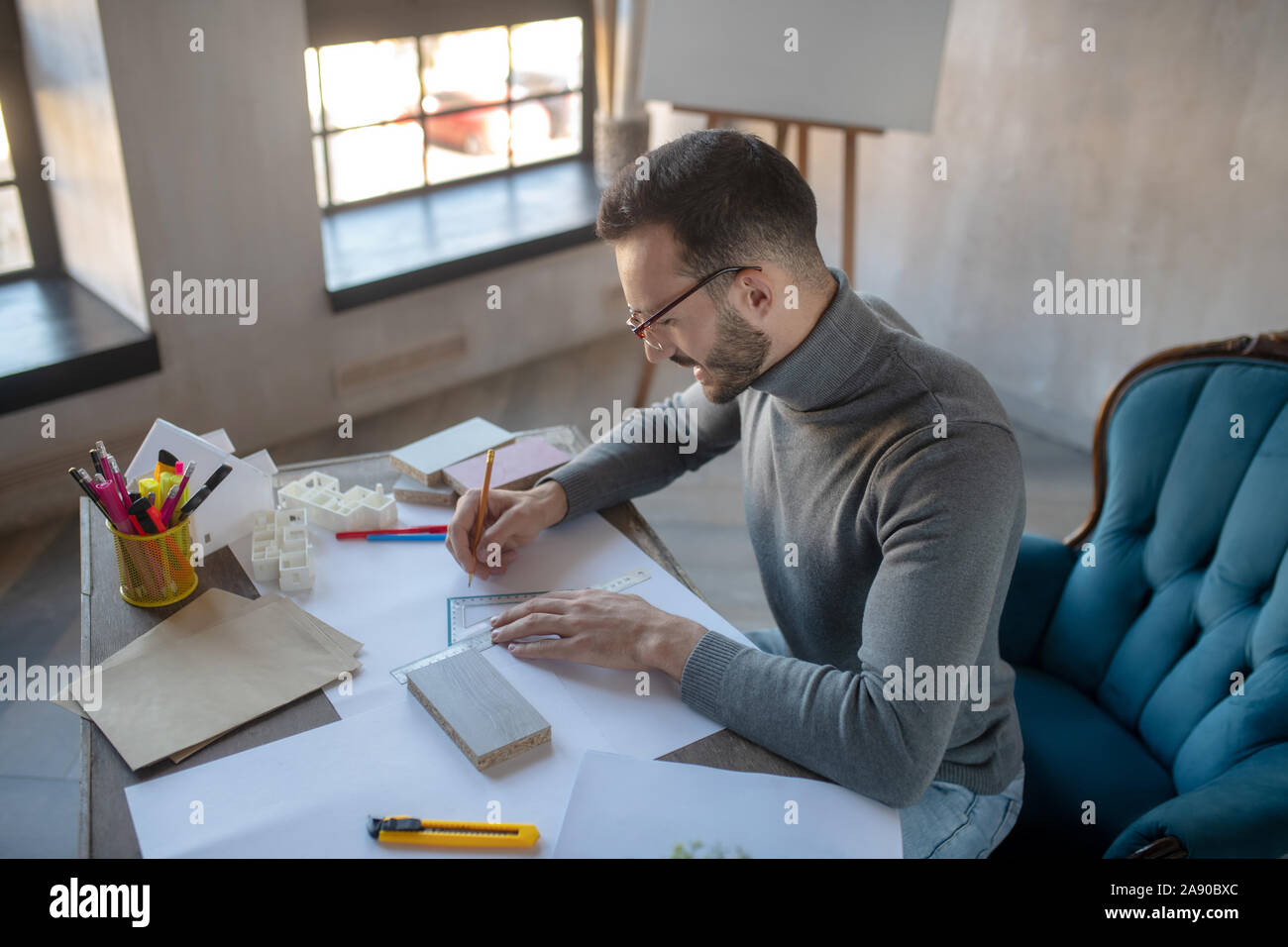 Interior designer making sketches with pencil and ruler Stock Photo - Alamy