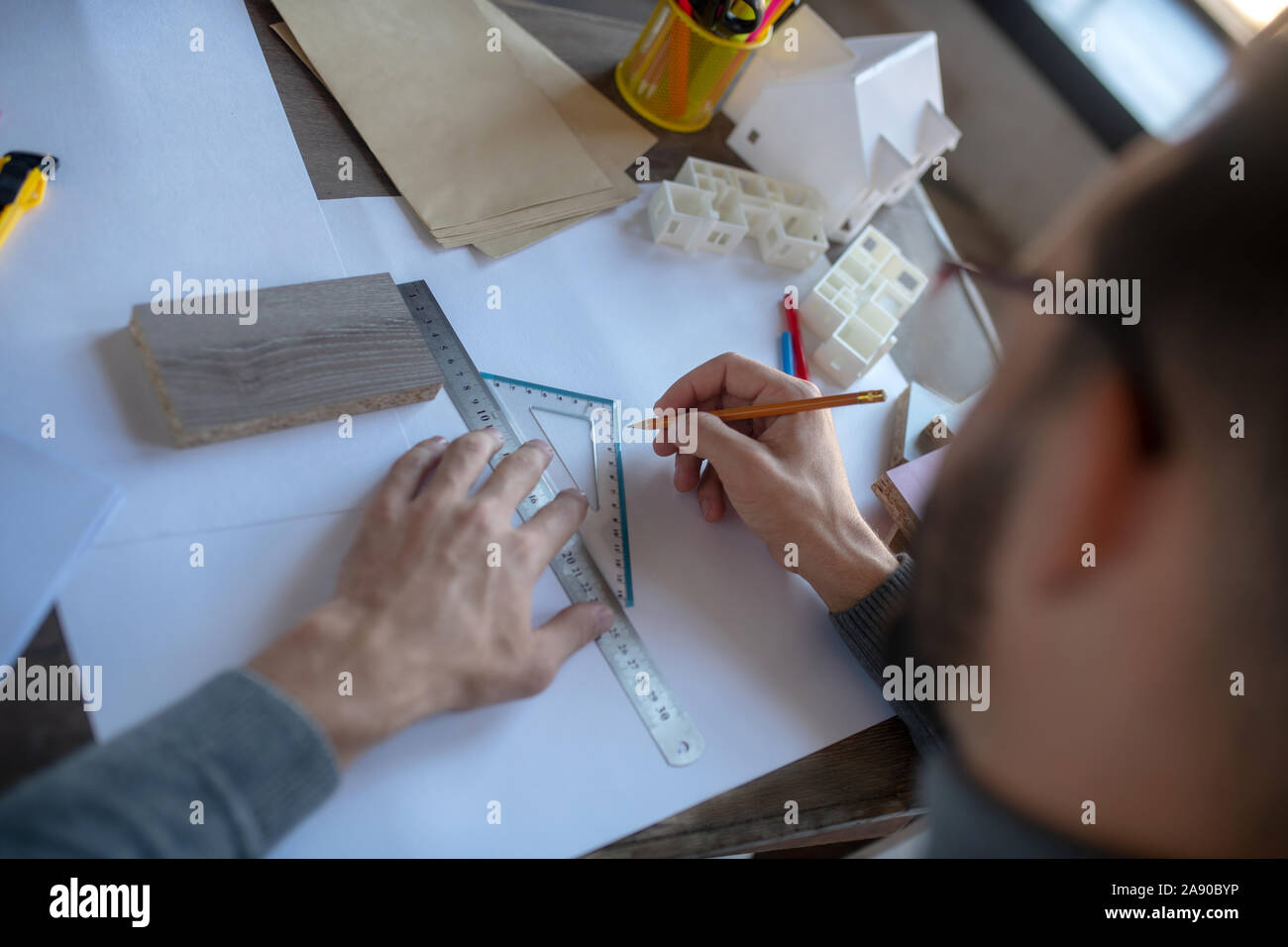 Close up of man using ruler and pencil while making sketches Stock ...