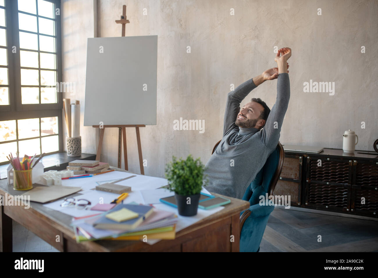 Cheerful man feeling satisfied after finishing new project Stock Photo ...