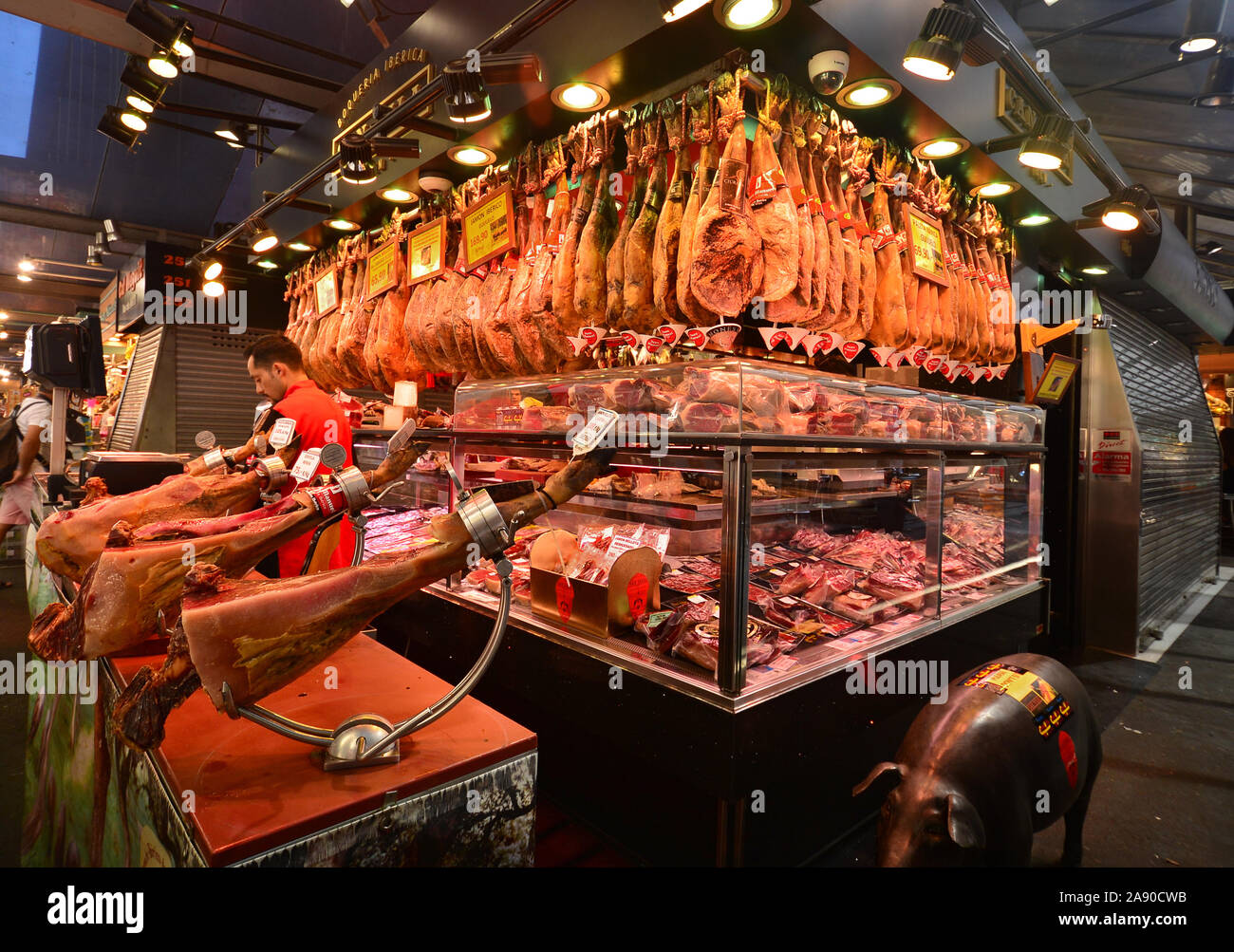 Stall displays spanish hams for sale in the La Boqueria market ...