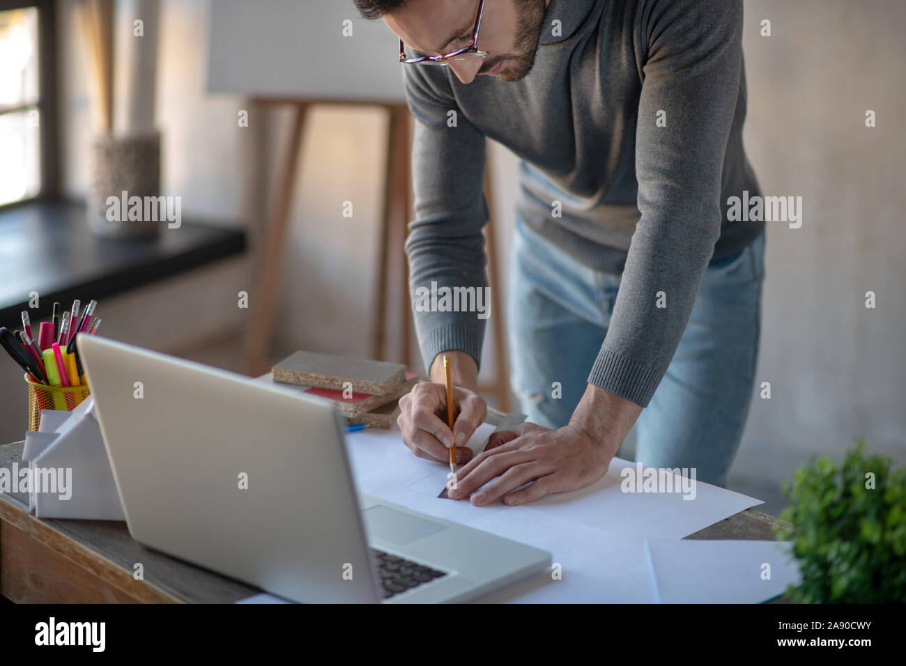 Serious prosperous interior designer working hard Stock Photo - Alamy