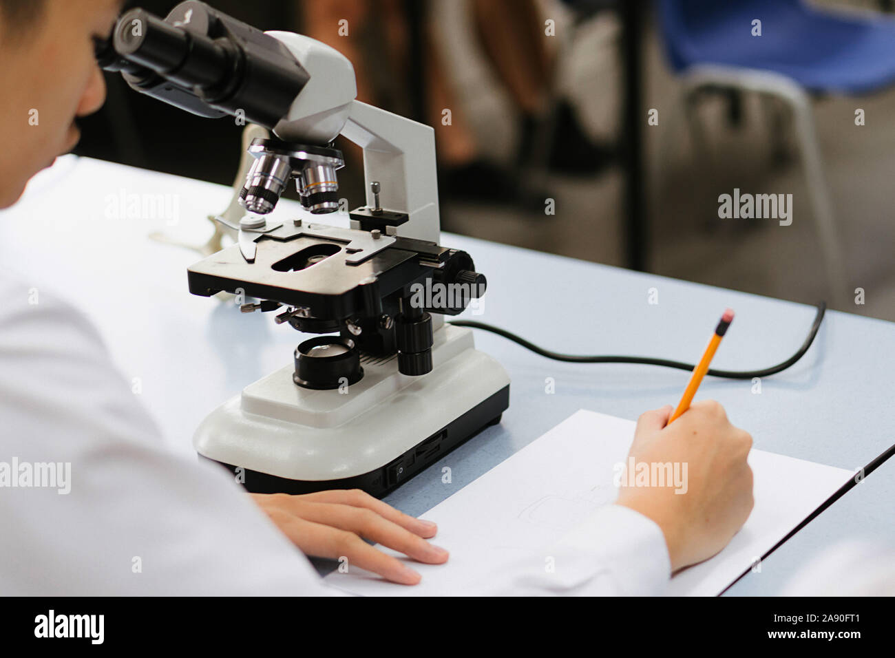 Student hand use pencil write down note in class Stock Photo - Alamy
