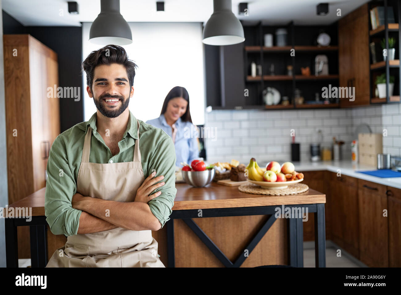 Happy young friends loving couple chefs on the kitchen cooking Stock ...