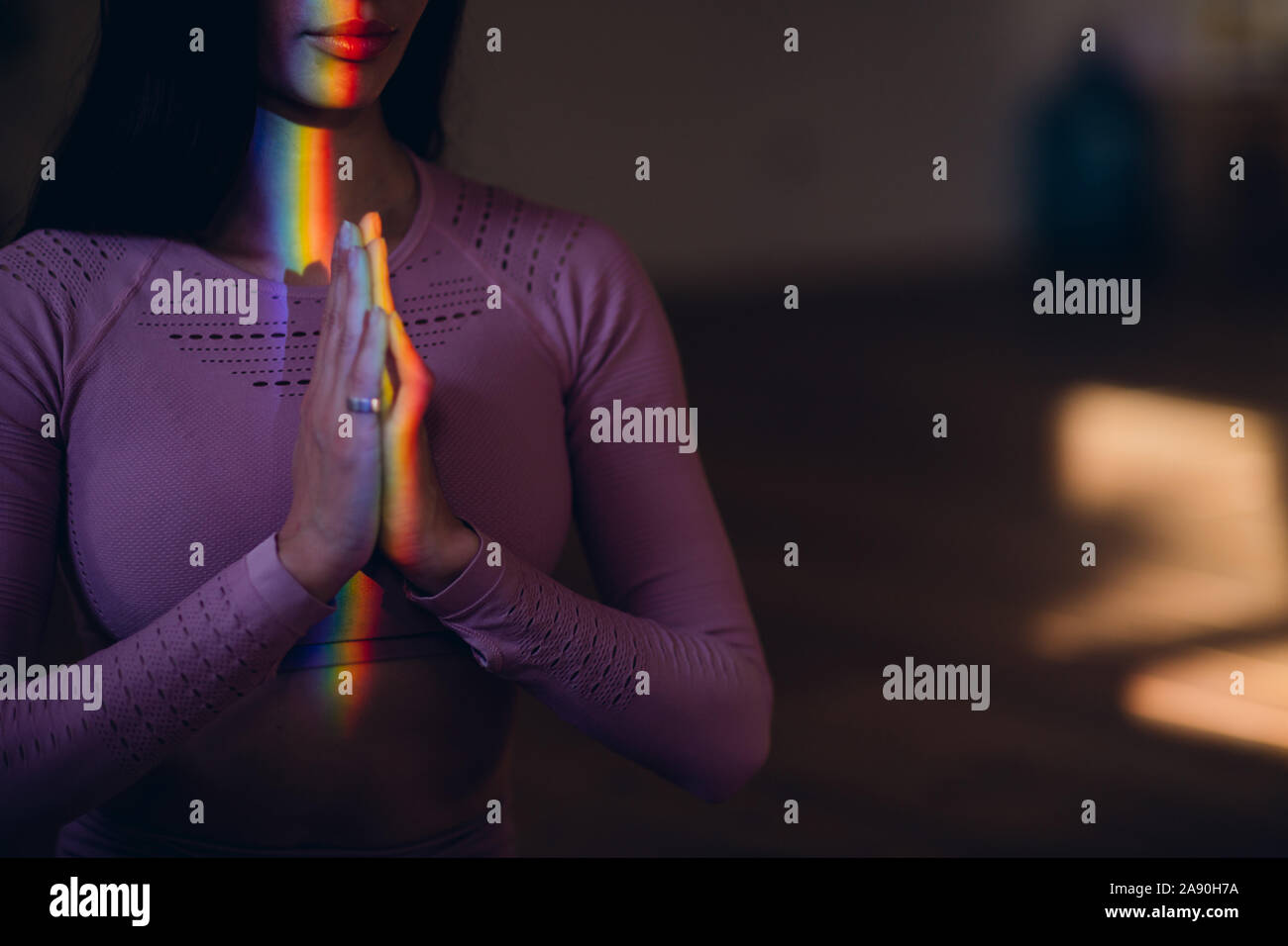 Hatha yoga concept. Woman practicing yoga with rainbow on her body ...
