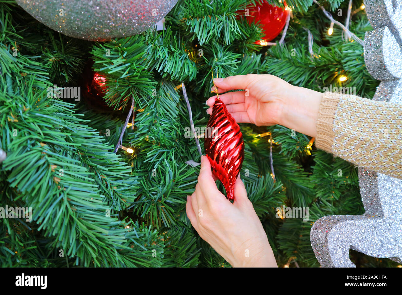 Womans hand decorating xmas tree hi-res stock photography and images ...