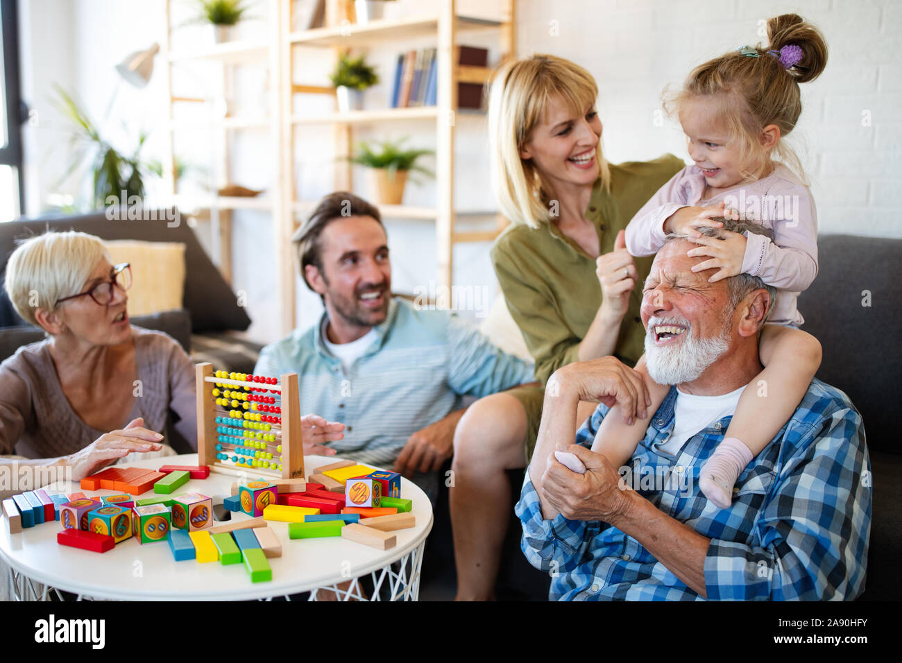 Senior grandparents playing with grandchildren and having fun with ...