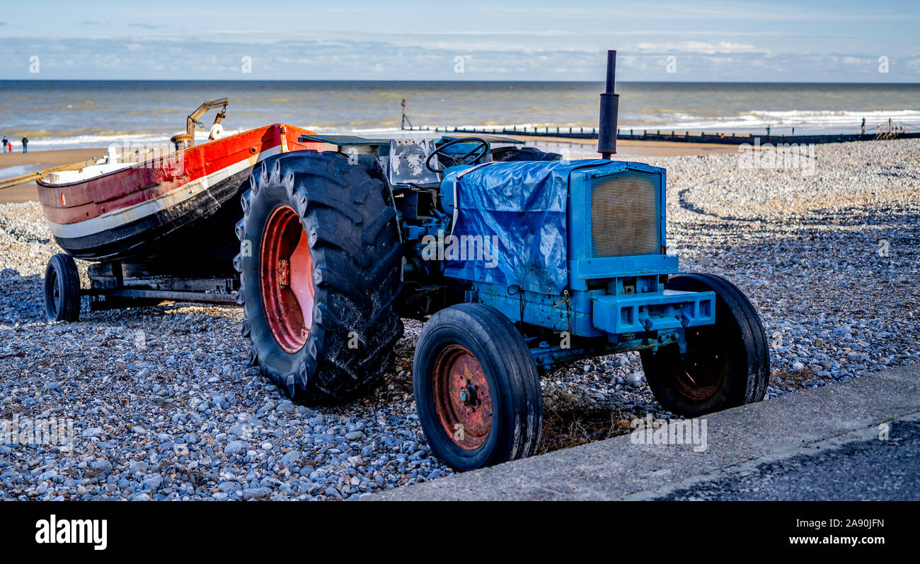 Tractor and traditional crab fishing boat on the back of a towing ...