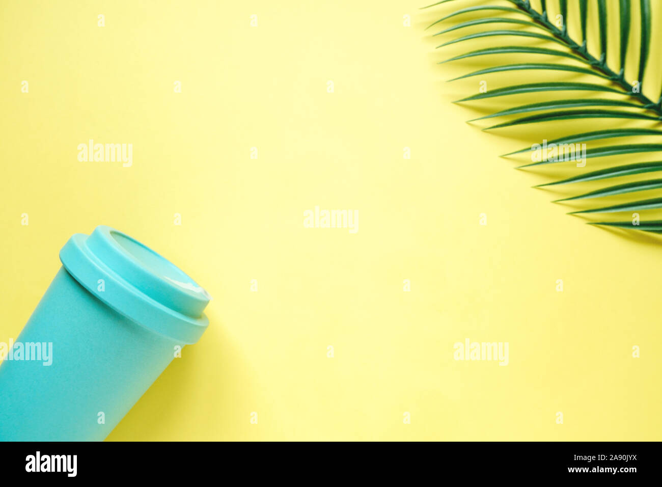 Glass mint color on a yellow background Stock Photo - Alamy