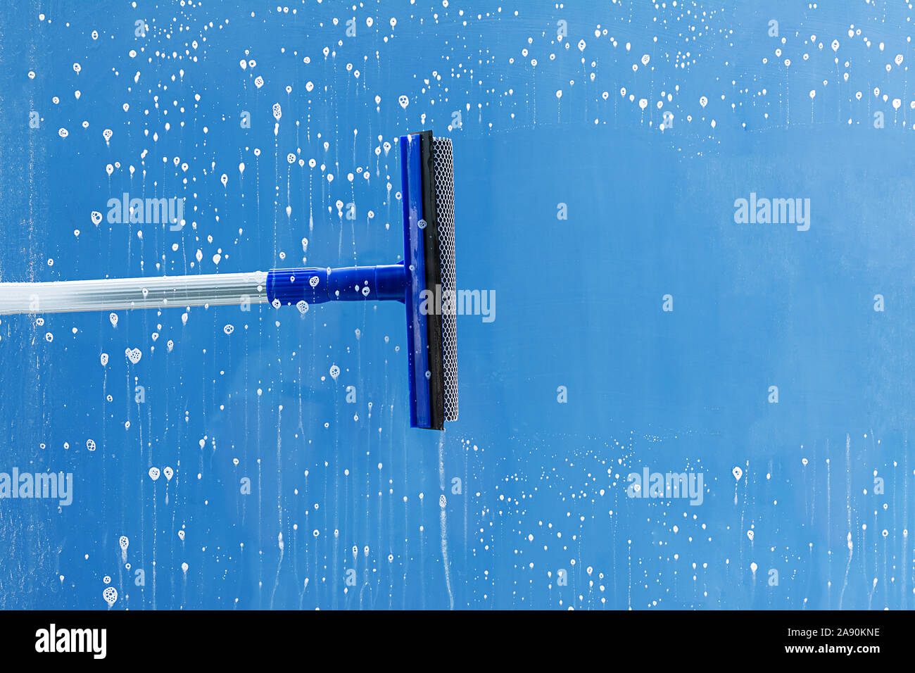 Rubber squeegee cleans window. Clears a stripe of soaped window ...