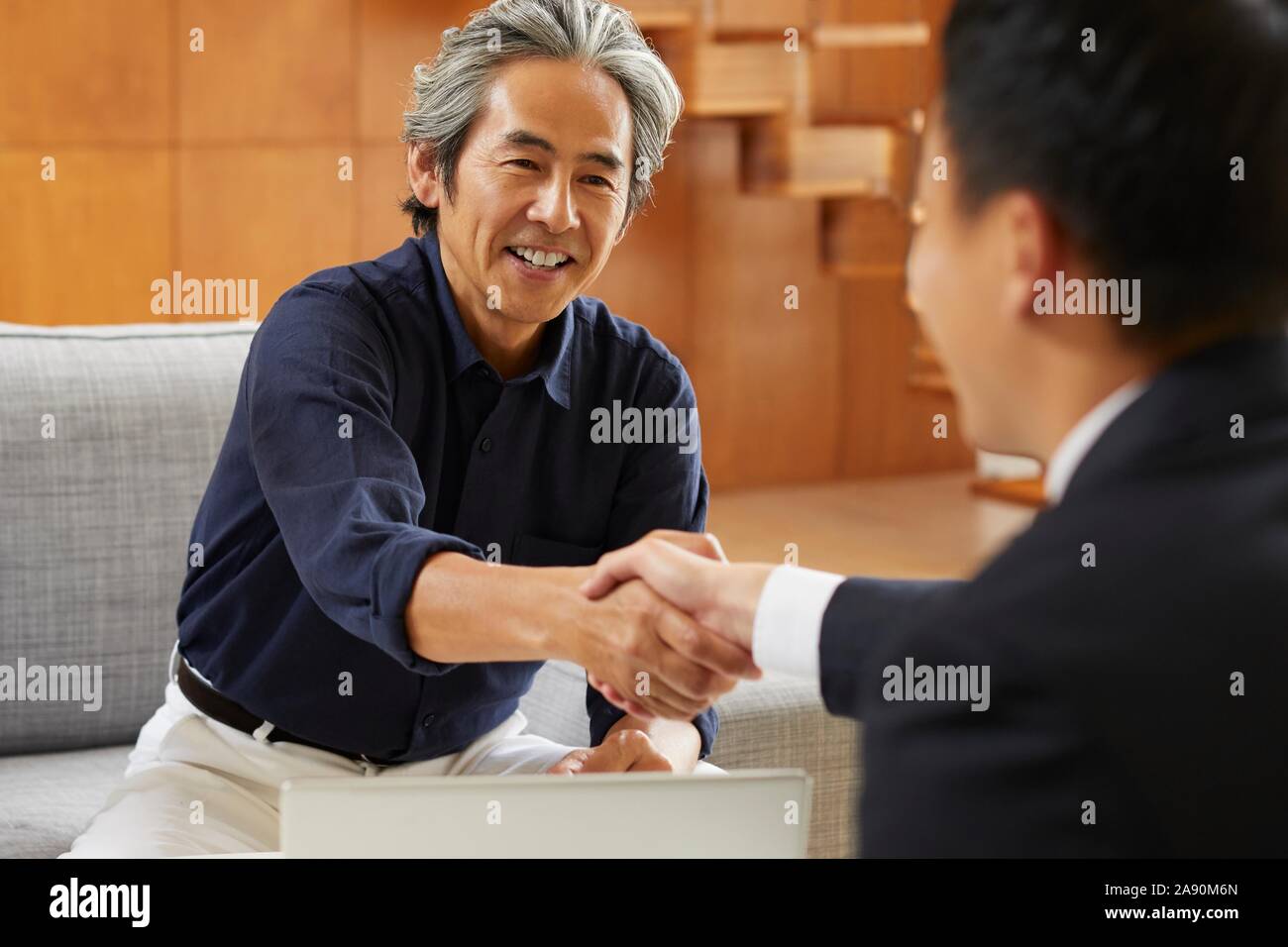 Senior Japanese man at home with salesman Stock Photo - Alamy