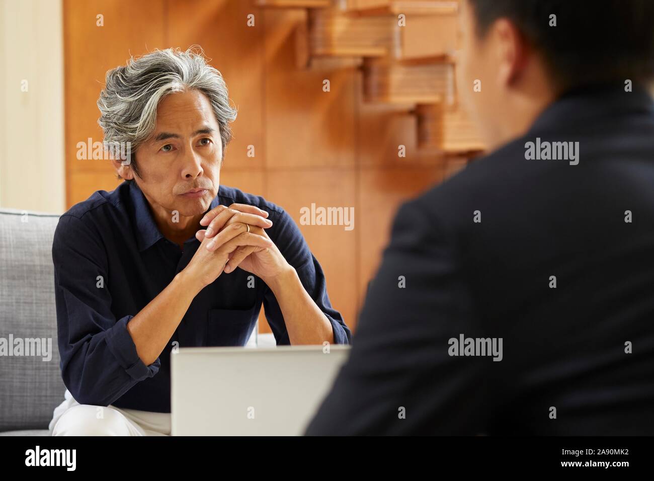 Senior Japanese couple at home with salesman Stock Photo - Alamy