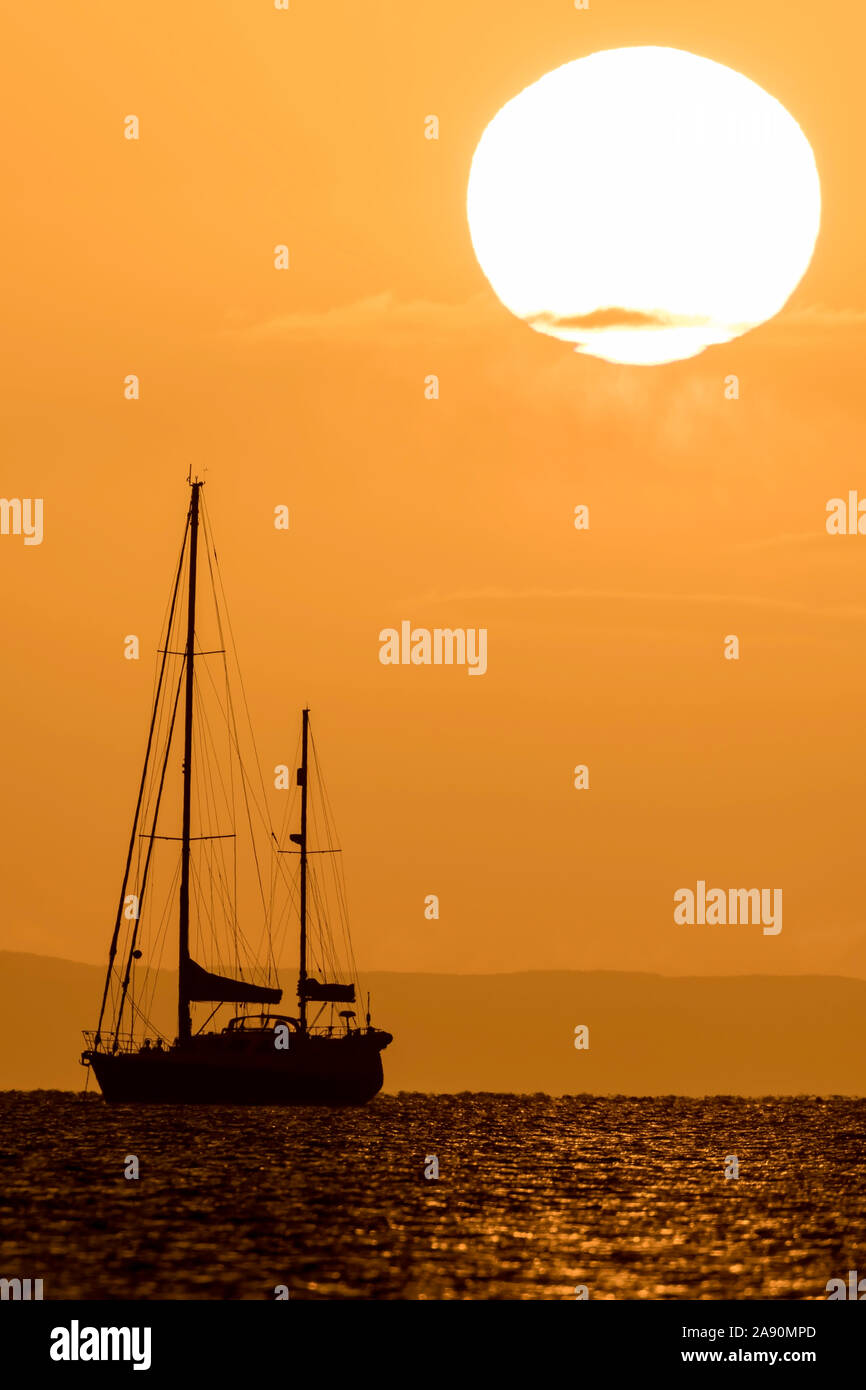 Sailing and a sun at the ocean morning Stock Photo - Alamy