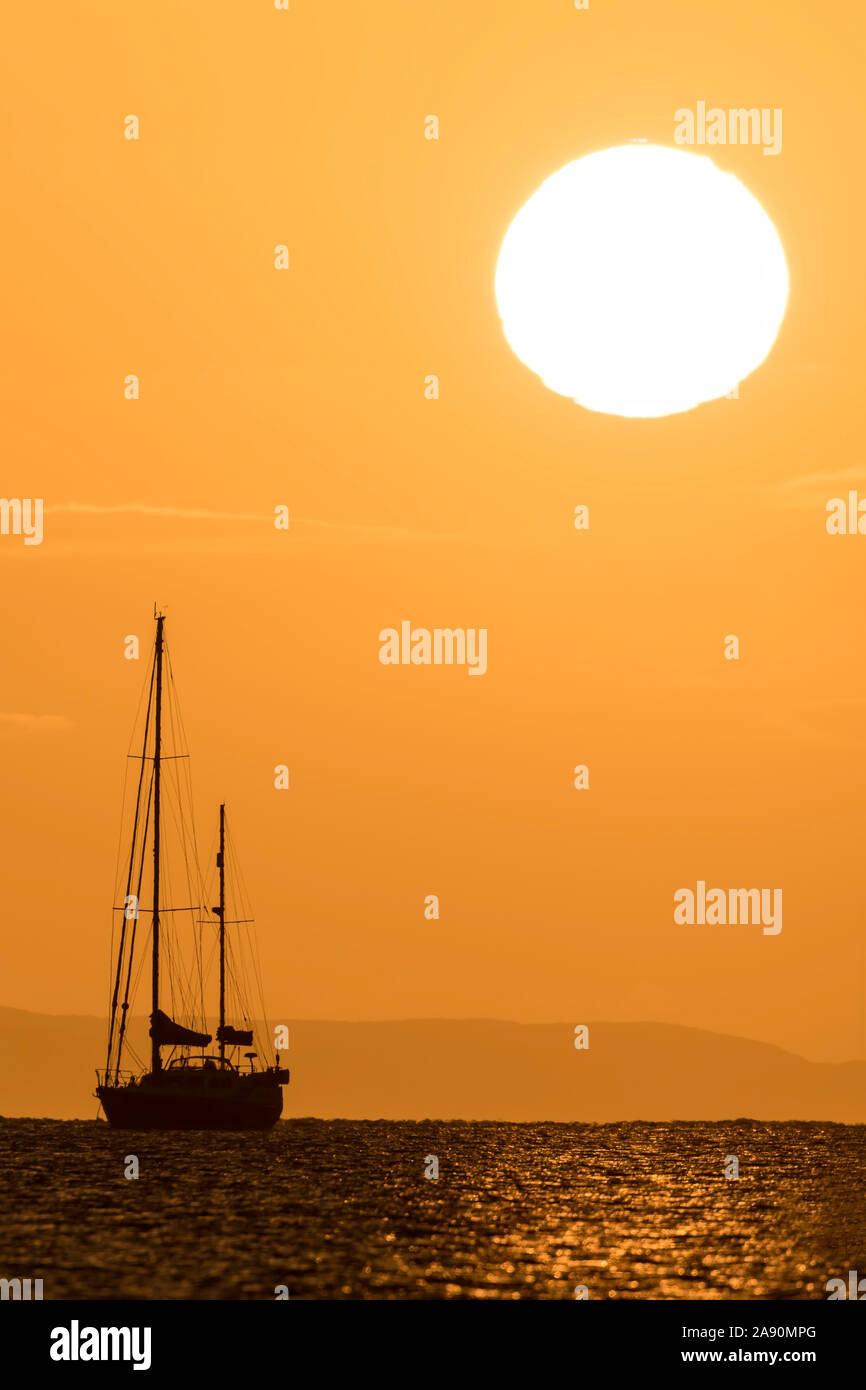 Sailing and a sun at the ocean morning Stock Photo - Alamy