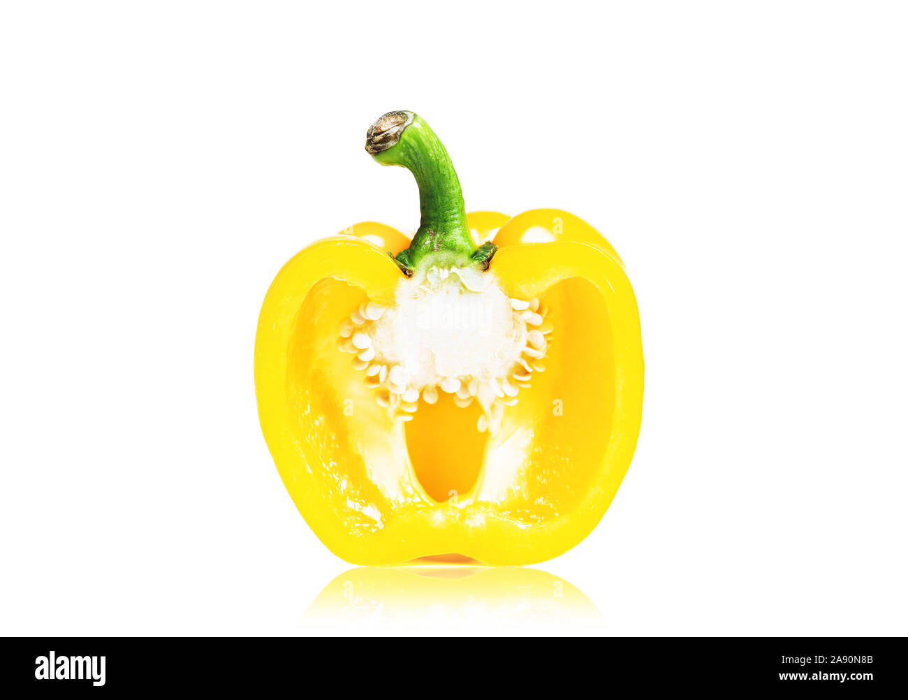 Fresh raw yellow pepper cut in half isolated on a white background ...