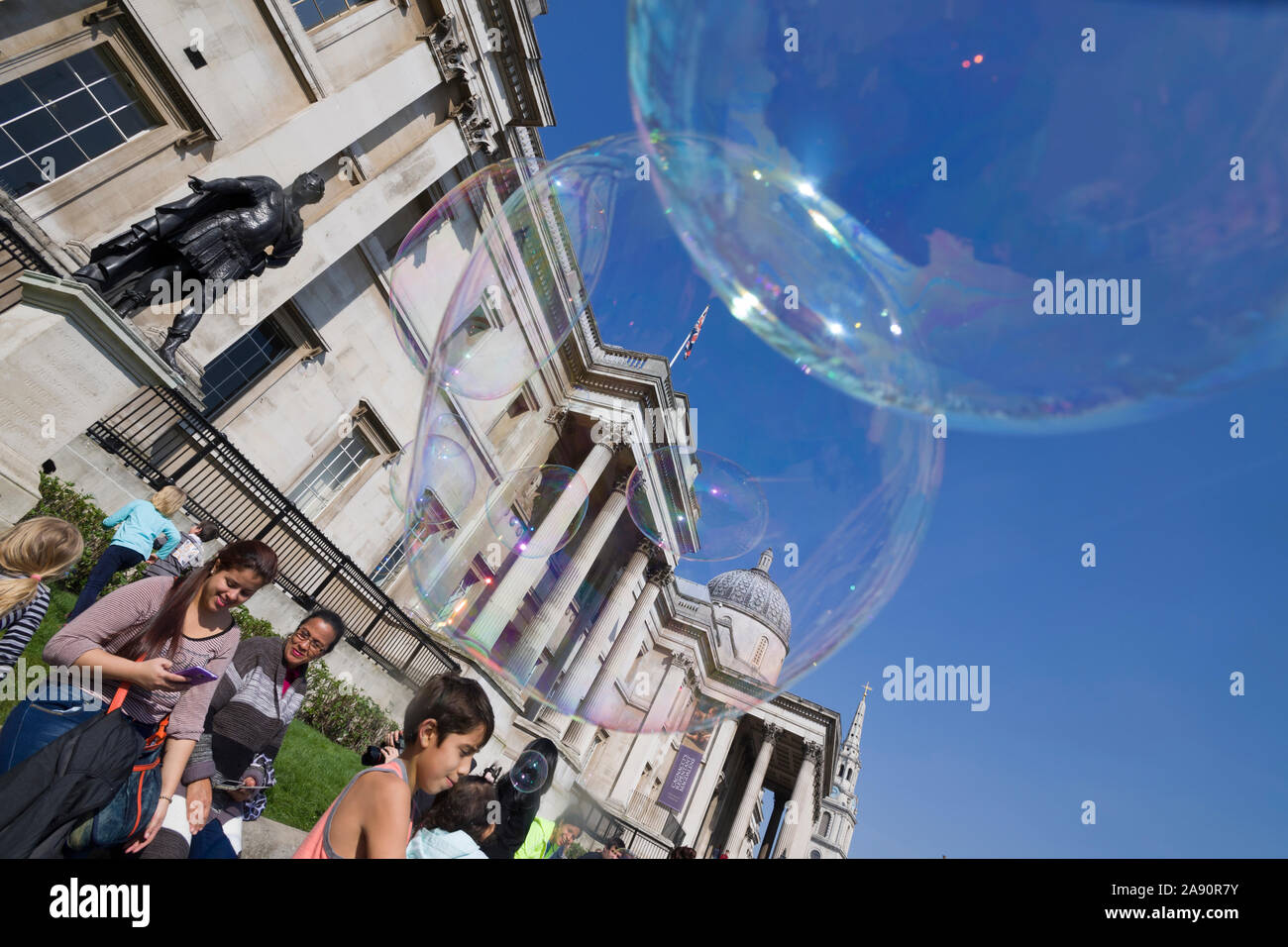 Bubbles created by a busker / street performer , in front of The ...