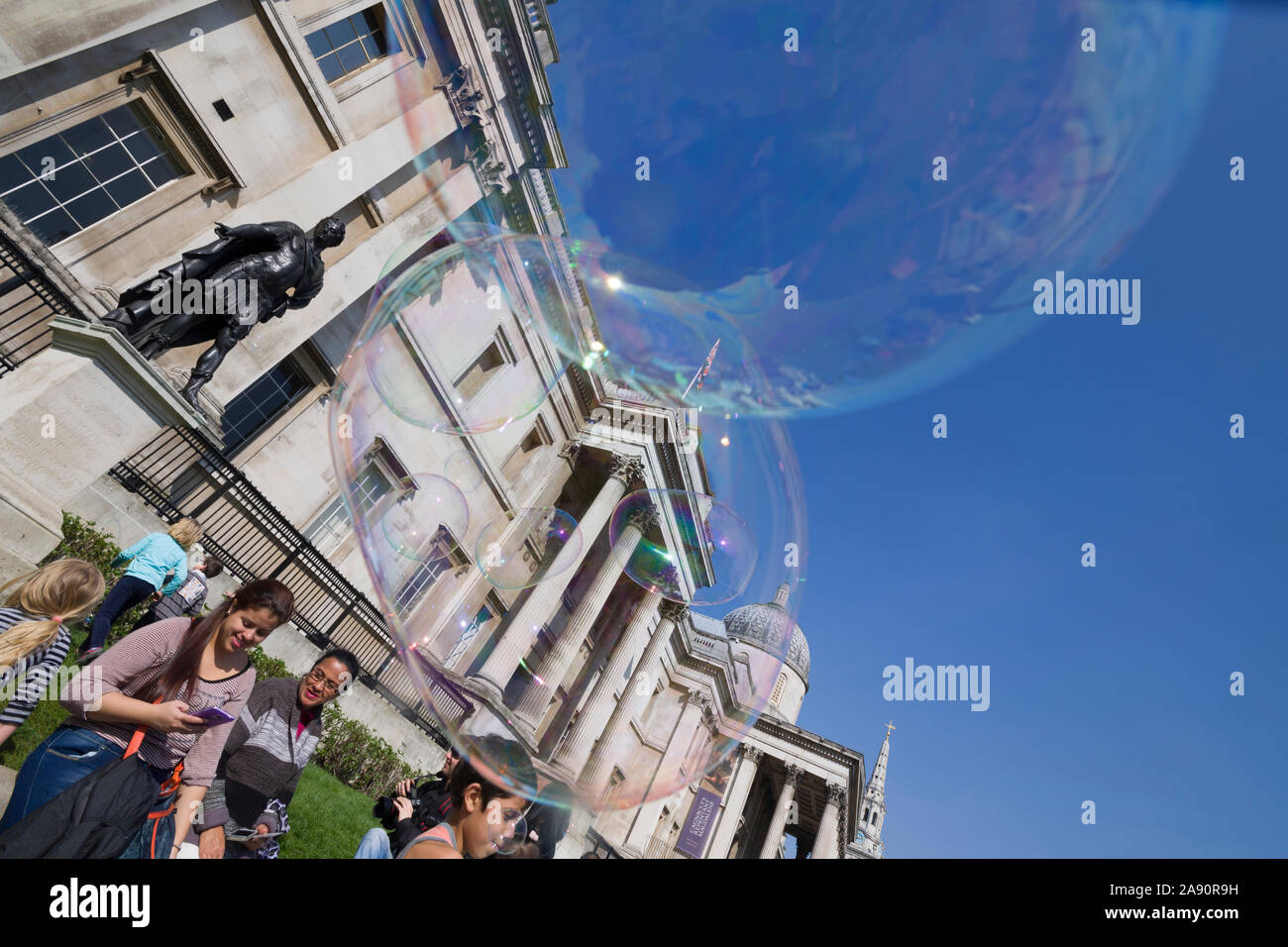 Bubbles created by a busker / street performer , in front of The ...