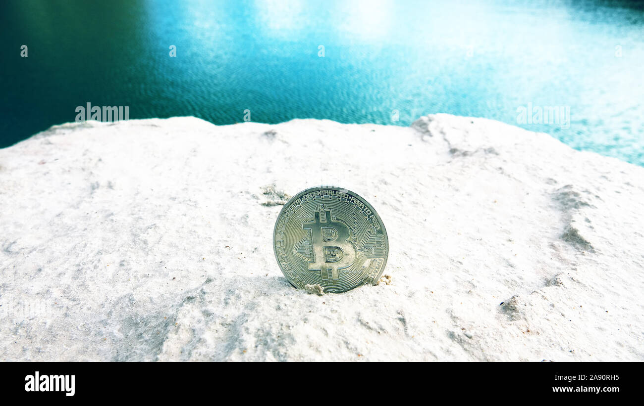 Bitcoin visualization on ocean on a tropical beach. Expensive coin and ...