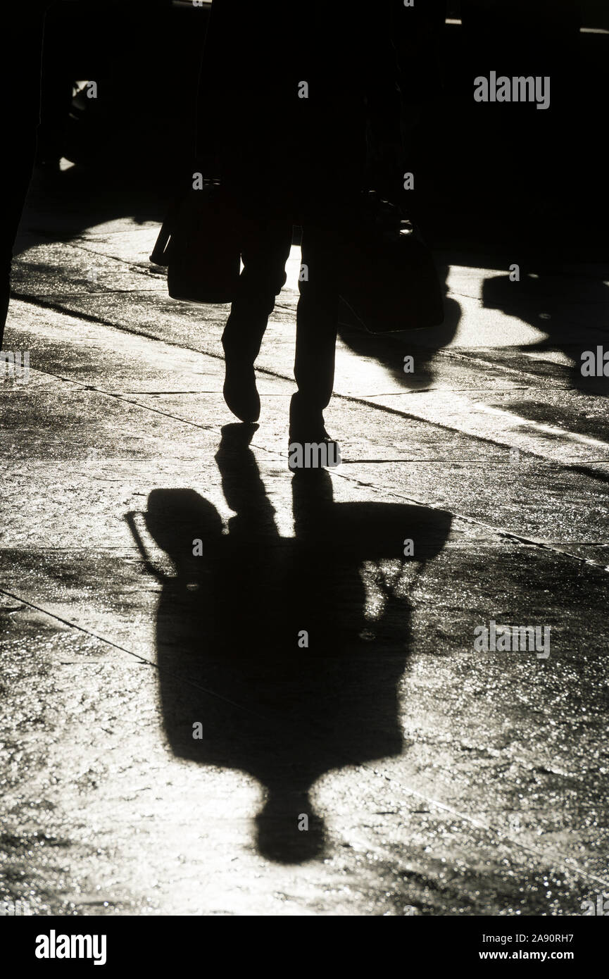 Shadows of people walking across Trafalgar Square, London, Britain ...