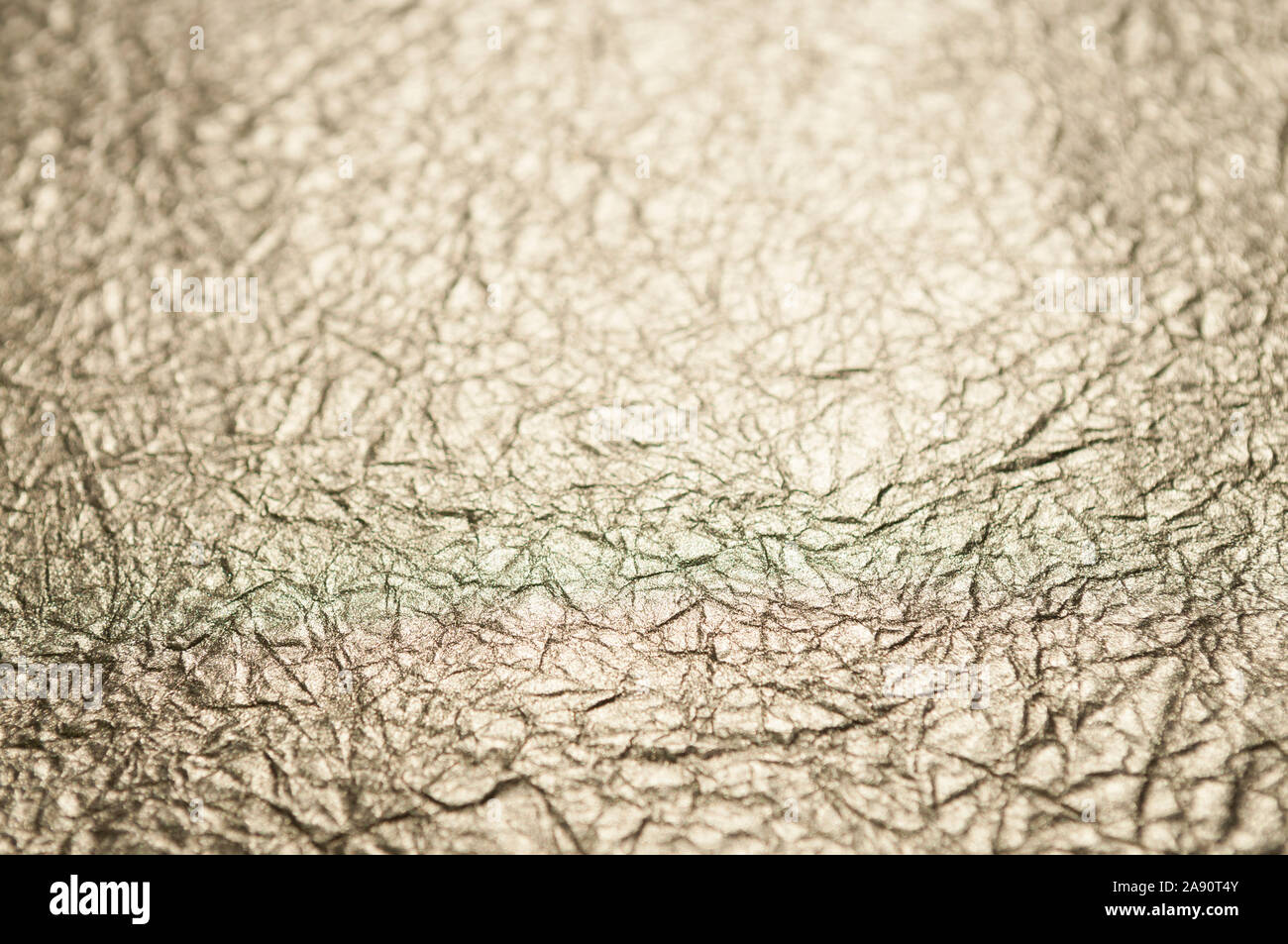 Shiny golden metallic wrapping paper in wrinkled textured holiday ...