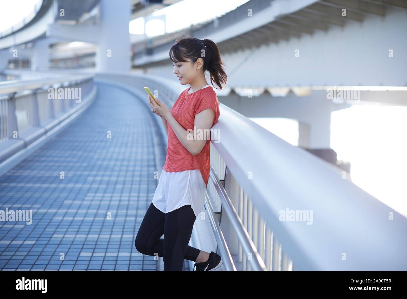 Young Japanese woman running downtown Tokyo Stock Photo - Alamy