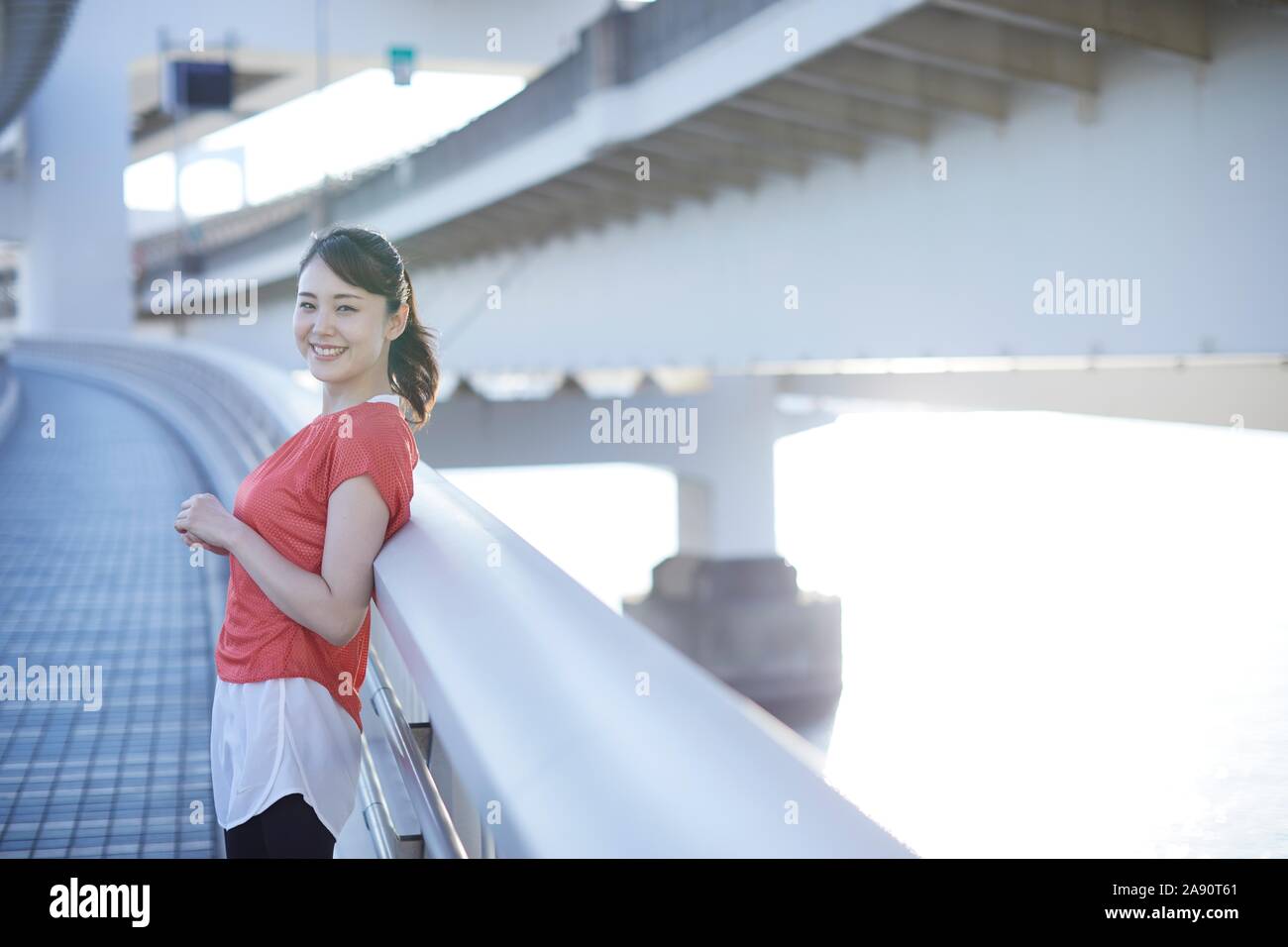 Young Japanese woman running downtown Tokyo Stock Photo - Alamy