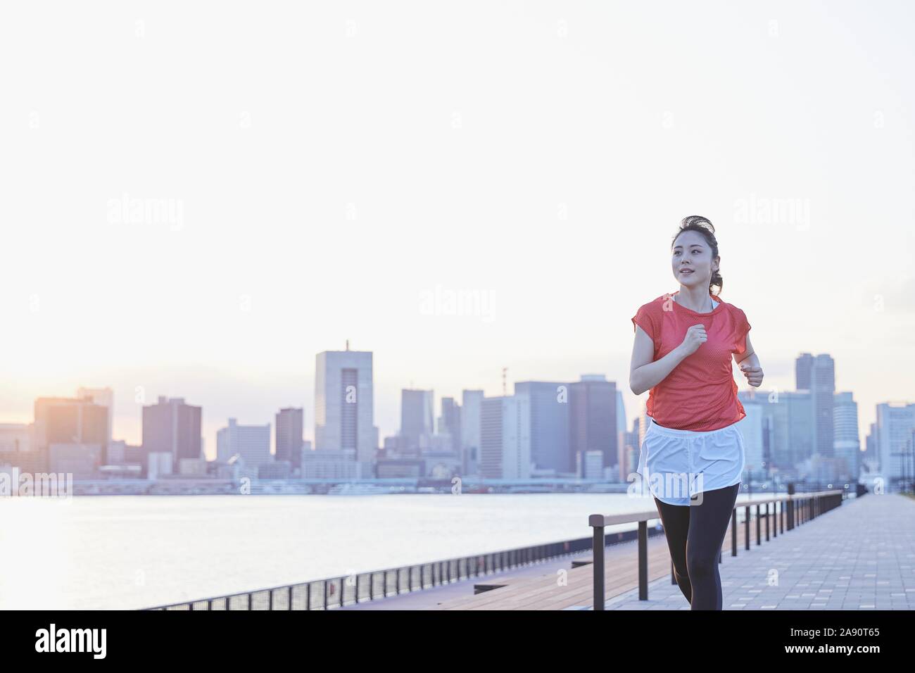 Young Japanese woman running downtown Tokyo Stock Photo - Alamy