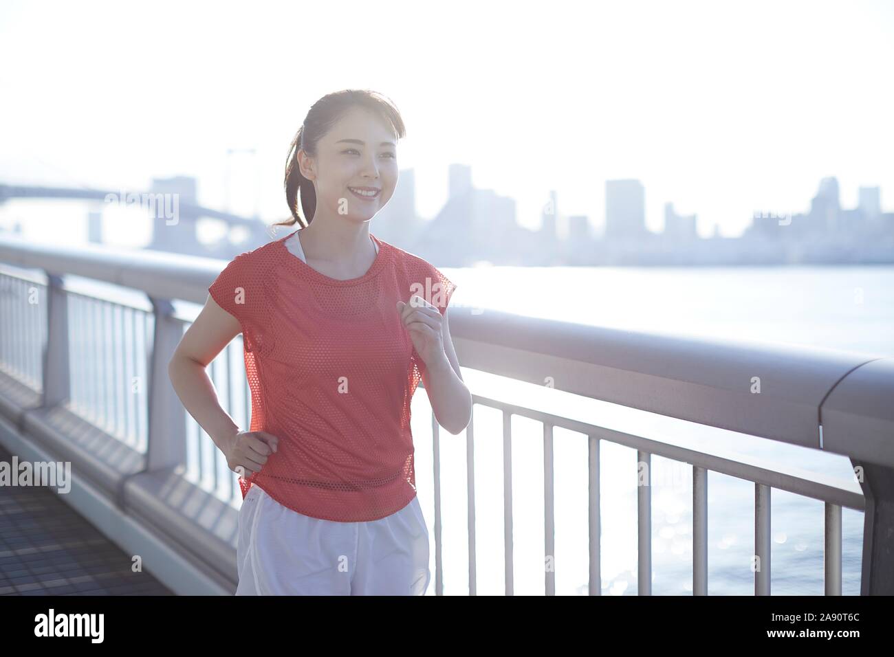 Young Japanese woman running downtown Tokyo Stock Photo - Alamy