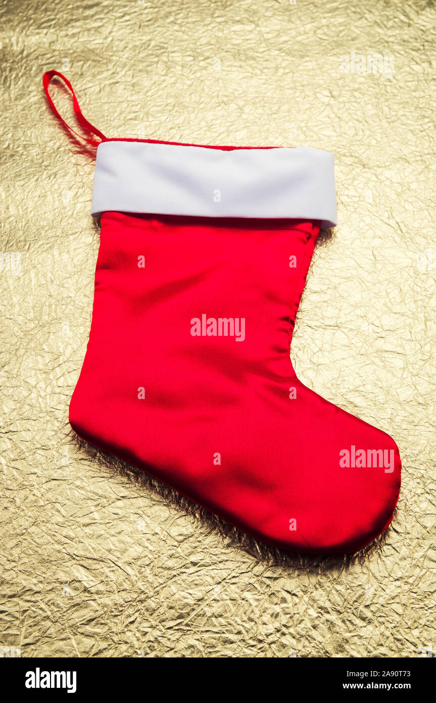 Simple Christmas stocking on festive gold background Stock Photo - Alamy