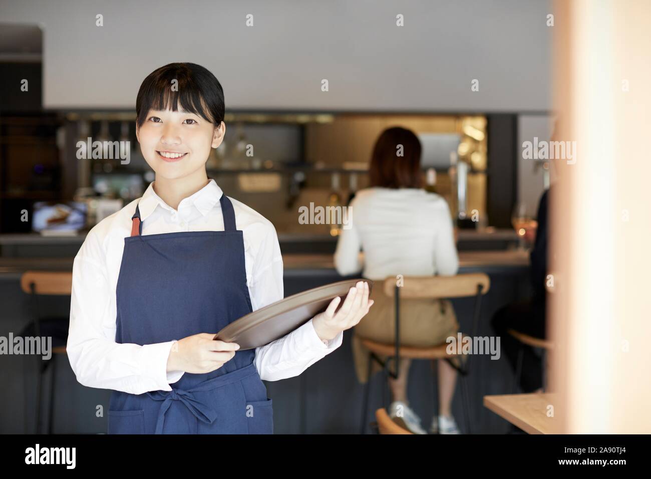 Young Japanese woman working at a restaurant Stock Photo - Alamy