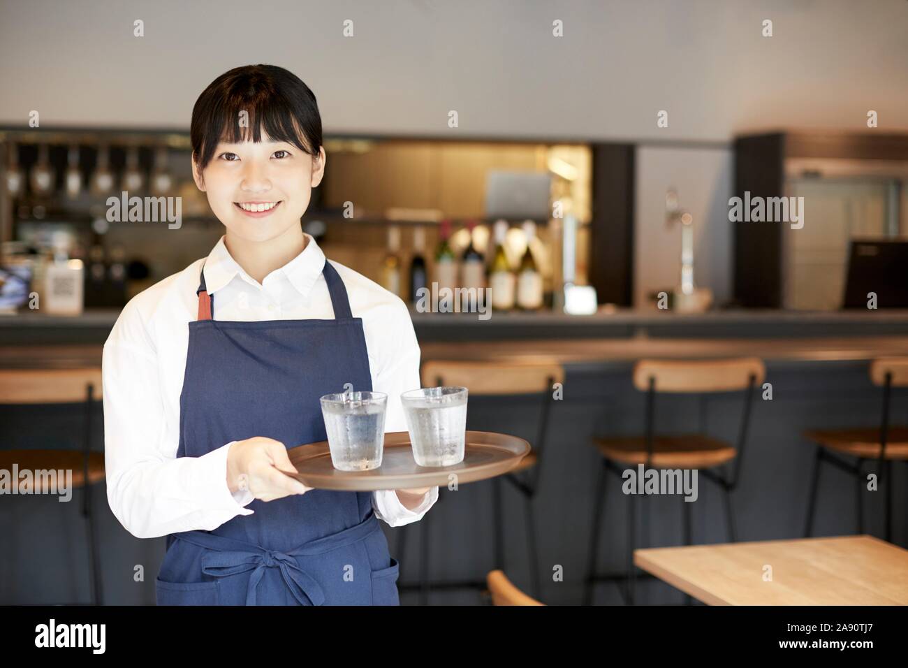 Young Japanese woman working at a restaurant Stock Photo - Alamy