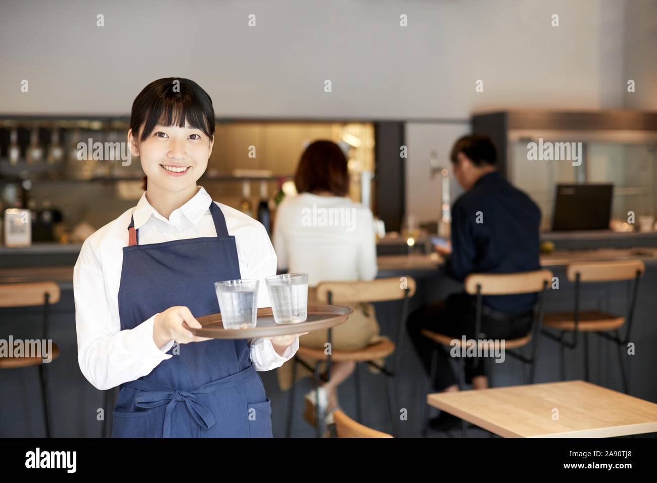 Young Japanese woman working at a restaurant Stock Photo - Alamy
