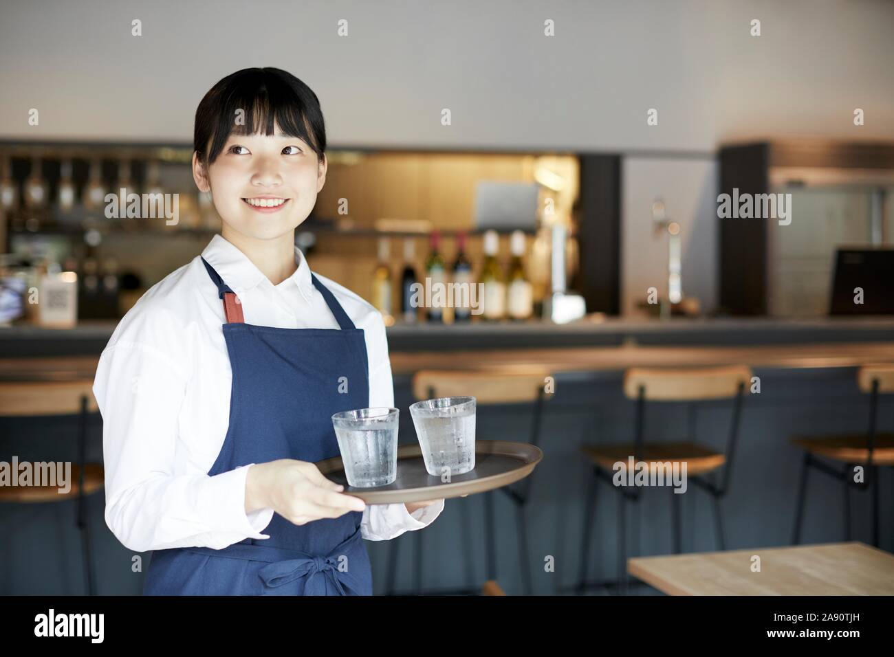 Young Japanese woman working at a restaurant Stock Photo - Alamy