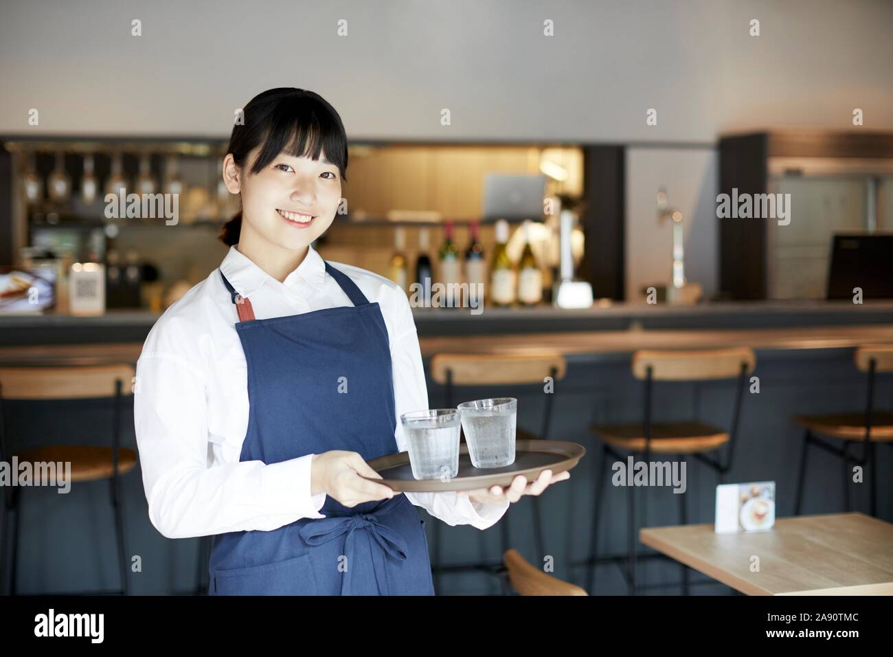 Young Japanese woman working at a restaurant Stock Photo - Alamy