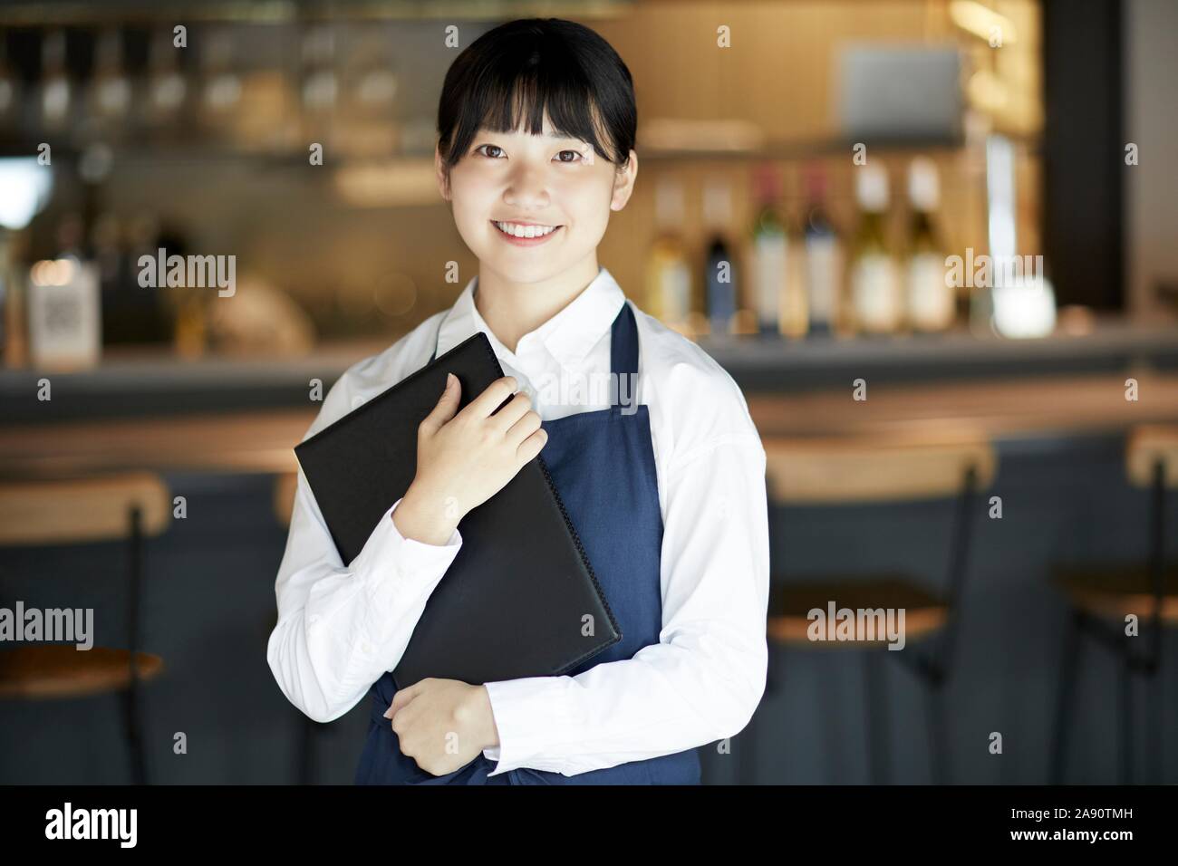 Young Japanese woman working at a restaurant Stock Photo - Alamy